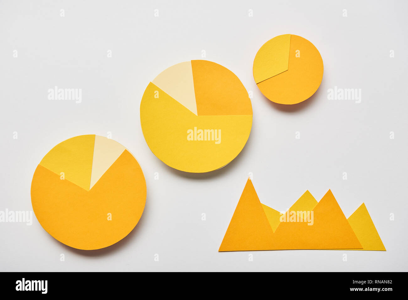 top view of paper yellow charts and graphs on white background Stock ...