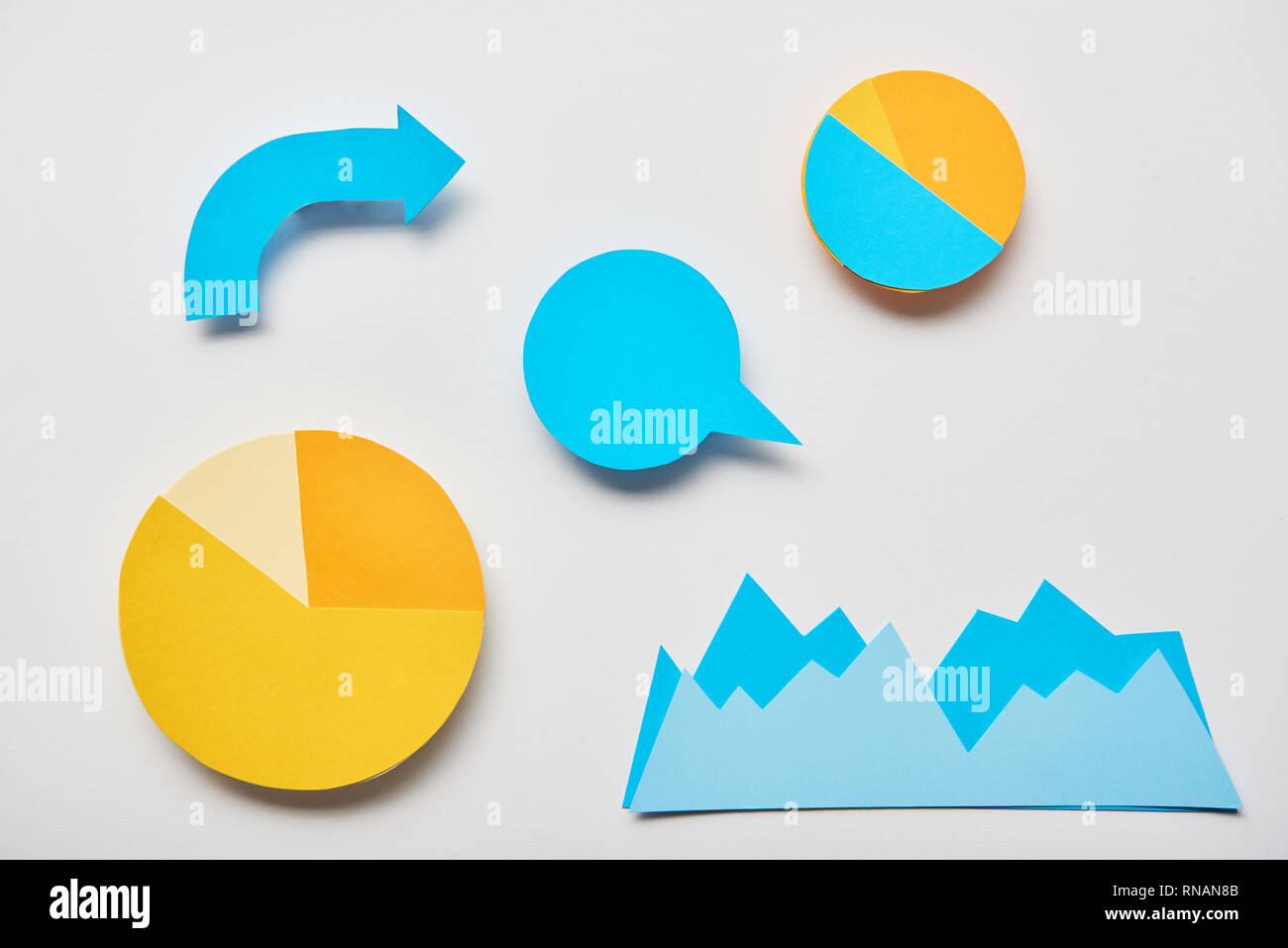 top view of paper blue and yellow charts and graphs, pointer on white ...