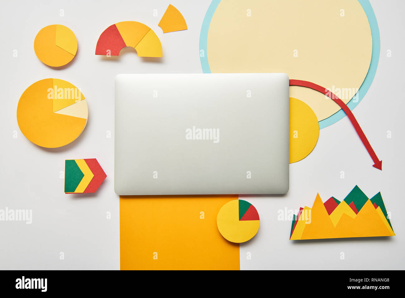 top view of laptop with paper charts and graphs, pointers, sheet of ...