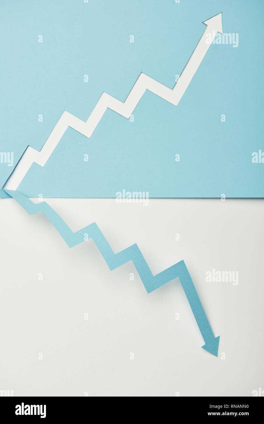 top view of symmetric situating paper pointers on white and blue ...