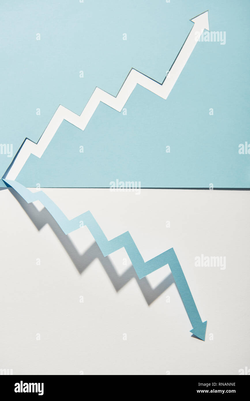 top view of symmetric paper pointers on white and blue background Stock ...