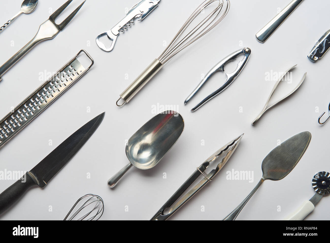 flat lay with shiny metal cooking utensils on grey background Stock ...