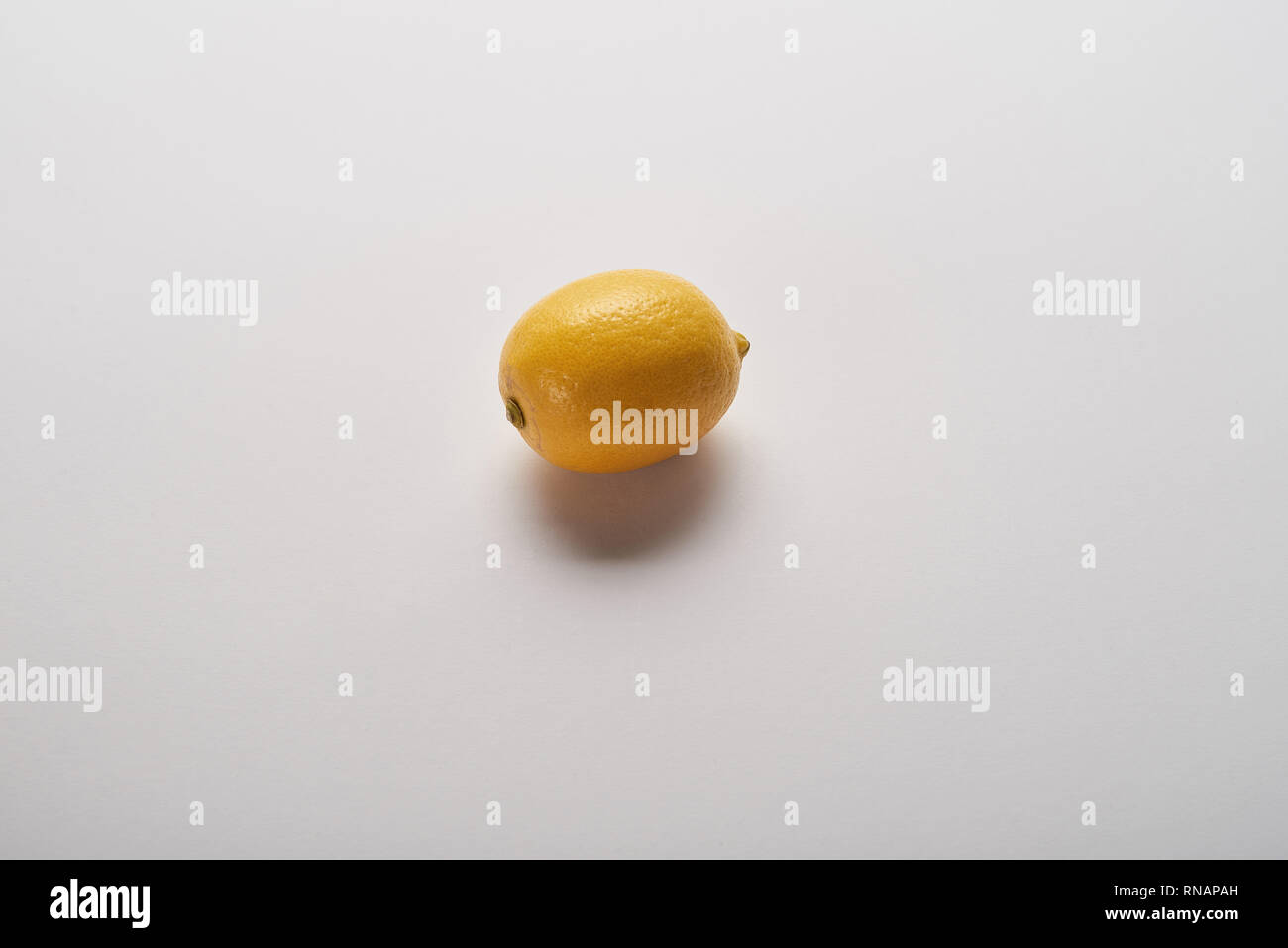 yellow ripe whole lemon on grey background Stock Photo - Alamy