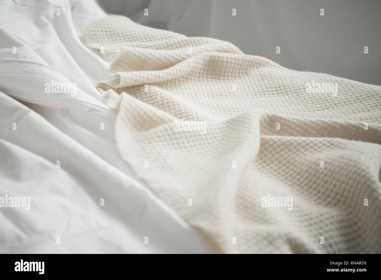 Close up of cozy empty bed with white blanket and sheets Stock Photo ...