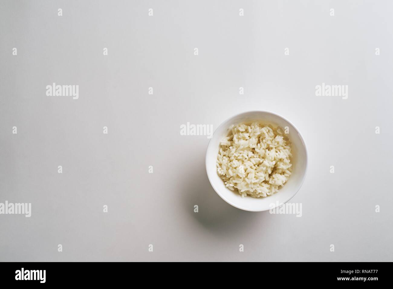 Cooked rice in plate isolated on white background Stock Photo - Alamy