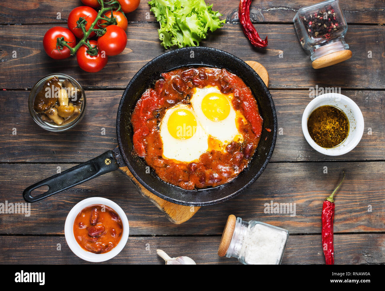 Shakshuka, Fried Eggs in Tomato Sauce in iron frying pan. Typical Israel food. Top view Stock ...