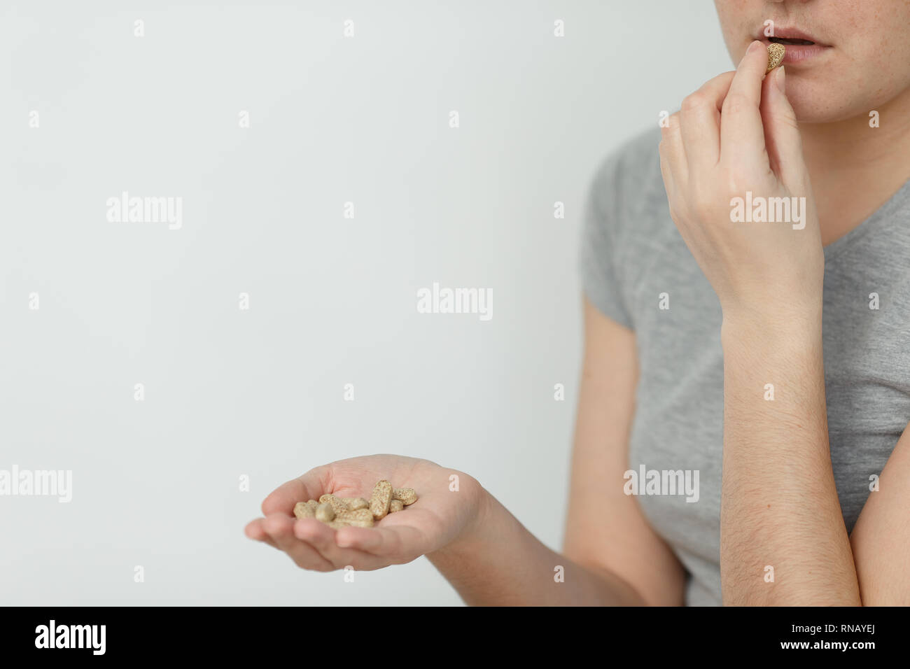 women are taking tablets on white background Stock Photo - Alamy