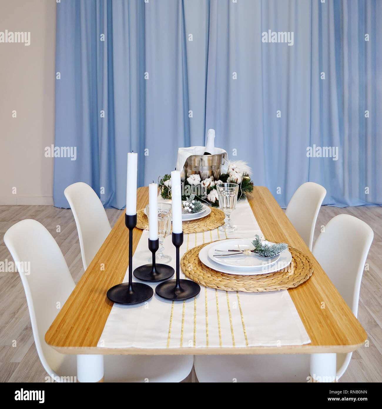 Christmas dinner by candlelight, table setting in in modern kitchen ...