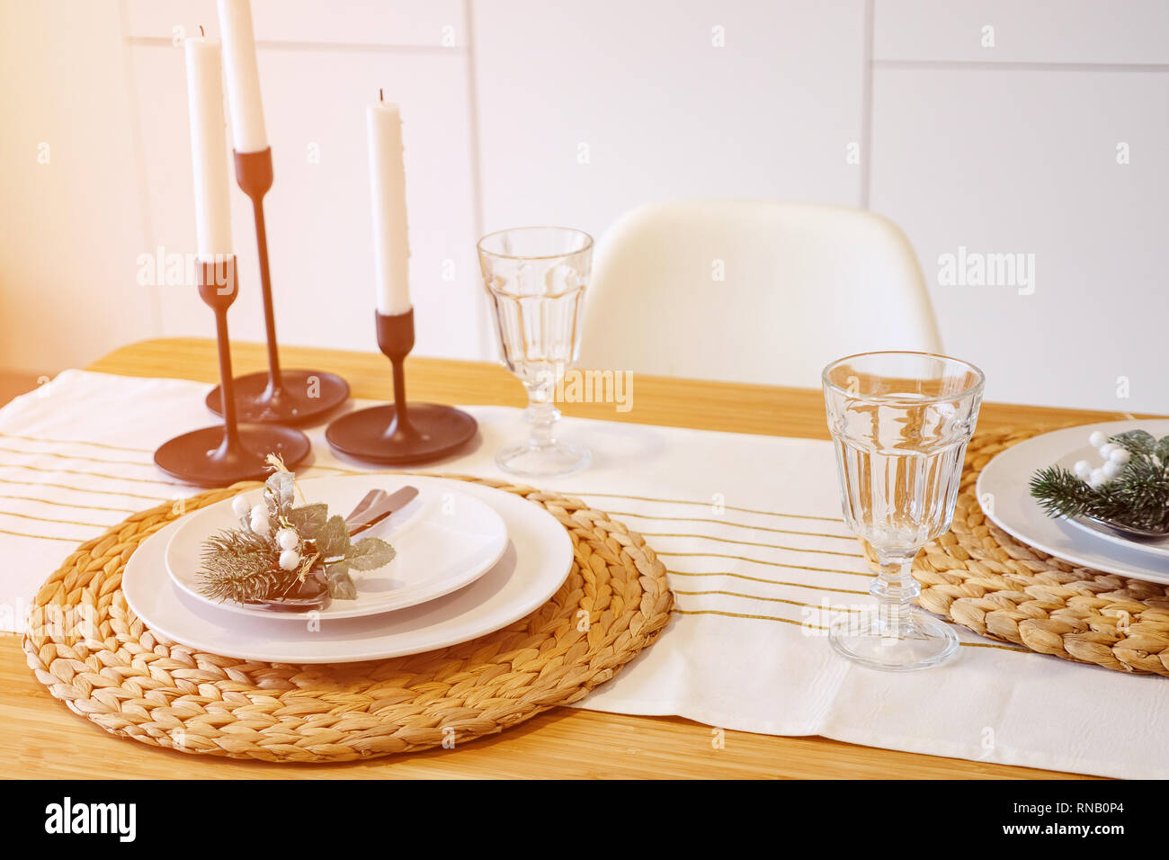 Christmas dinner by candlelight, table setting in in modern kitchen ...