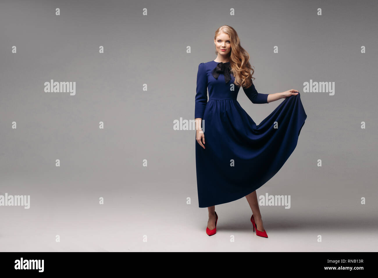 Stunning slim model in bright blue dress and black heels Stock Photo ...