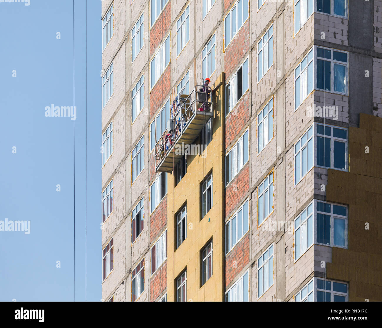 Facade work and insulation of a multistory building Stock Photo - Alamy