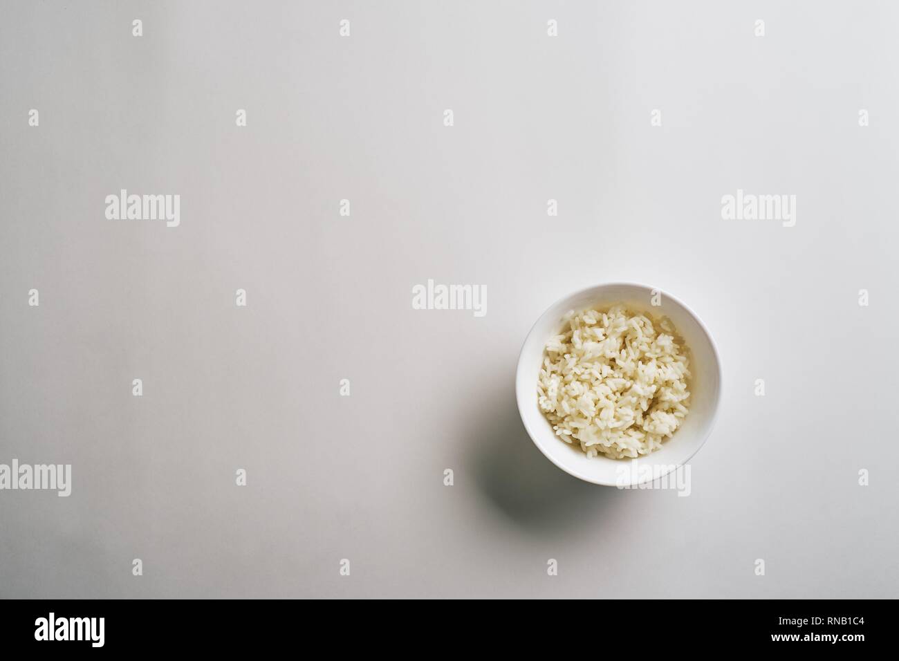 Cooked rice in plate isolated on white background Stock Photo - Alamy
