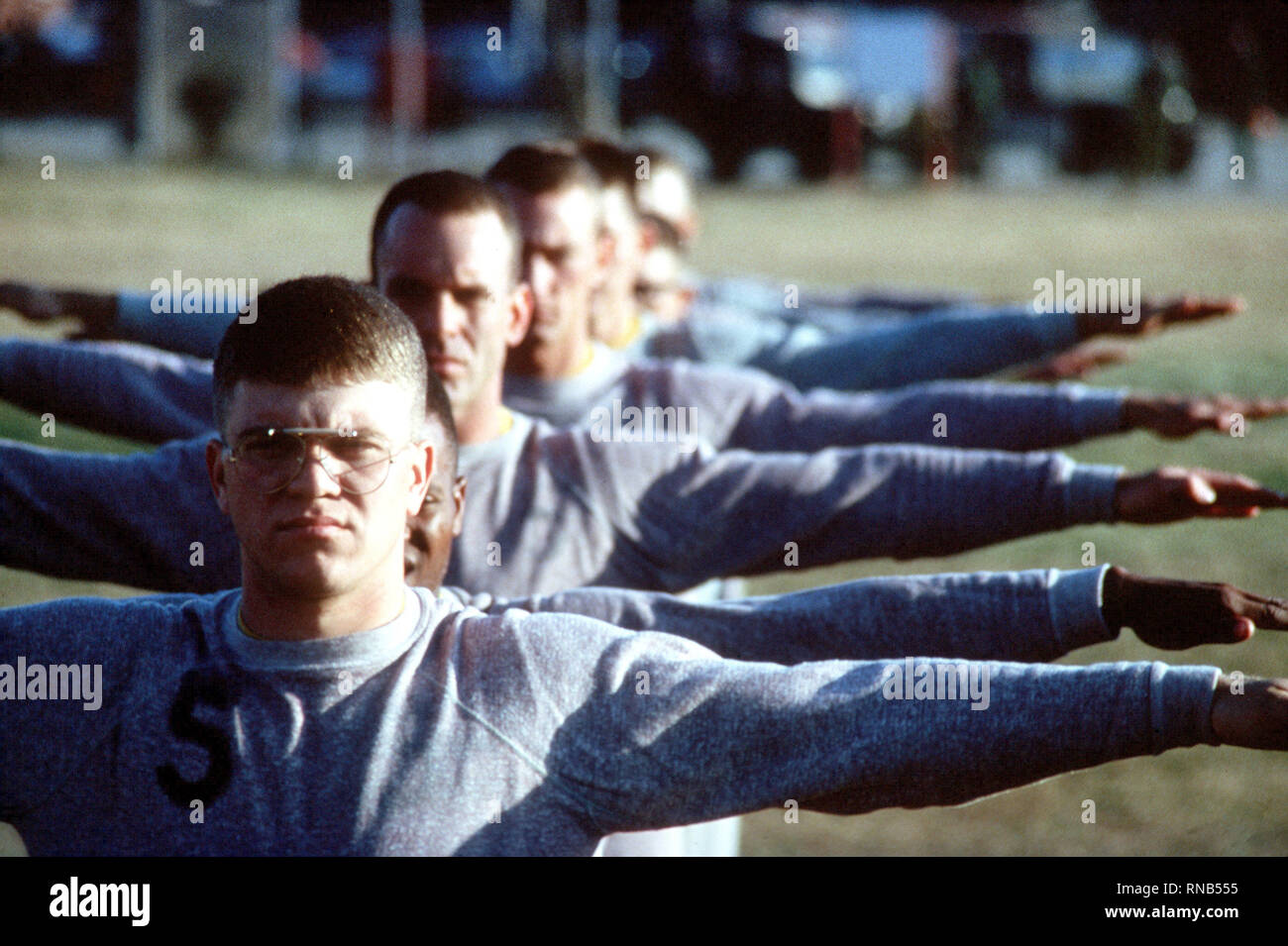 1980 - A column of Marine officer candidates prepare to do an arm ...