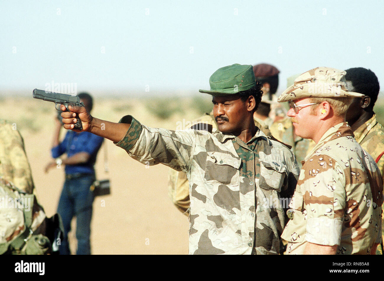 A Sudanese soldier fires a U.S. .45-caliber automatic pistol during ...