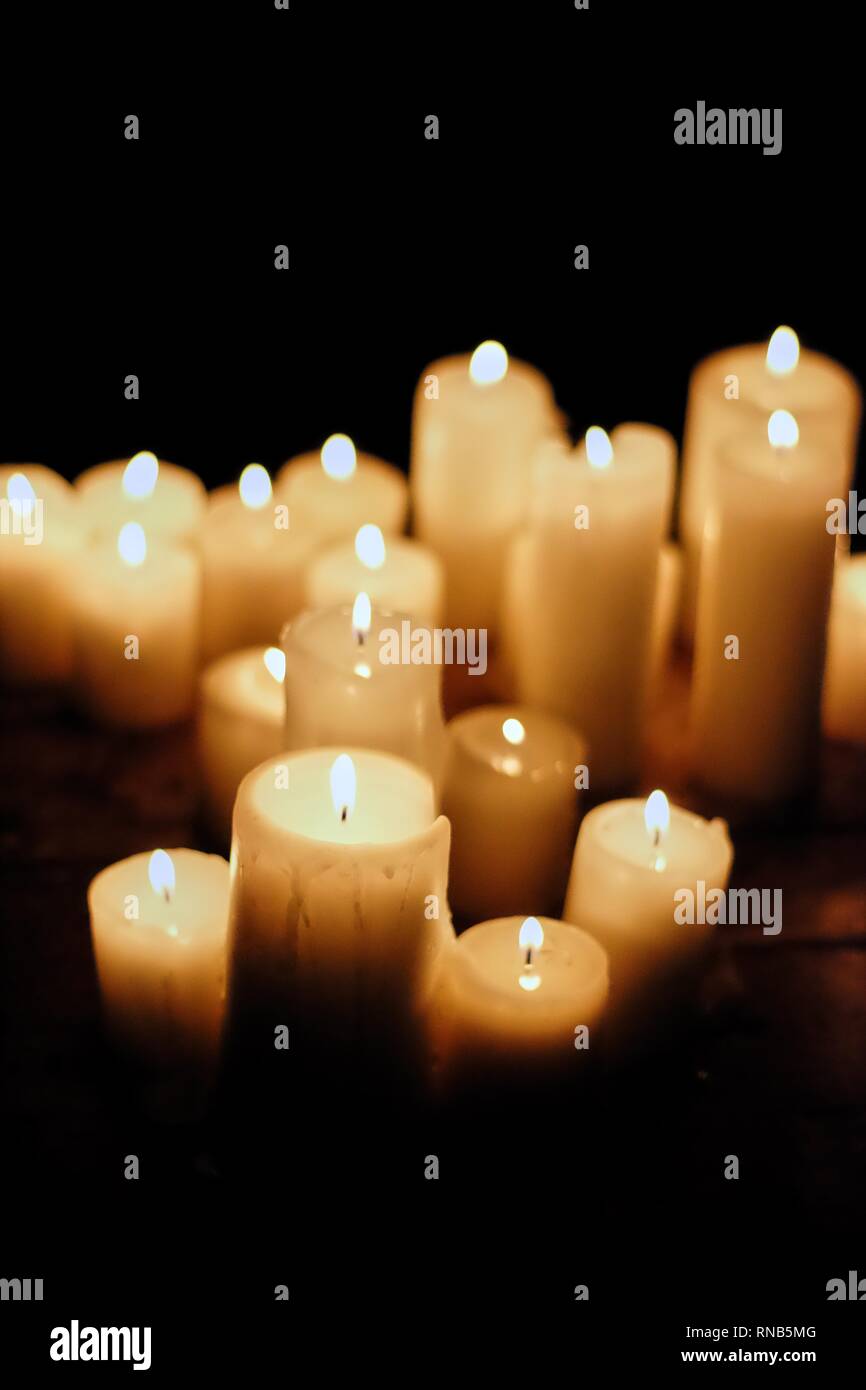 Candles black background isolated dark night low light Stock Photo - Alamy