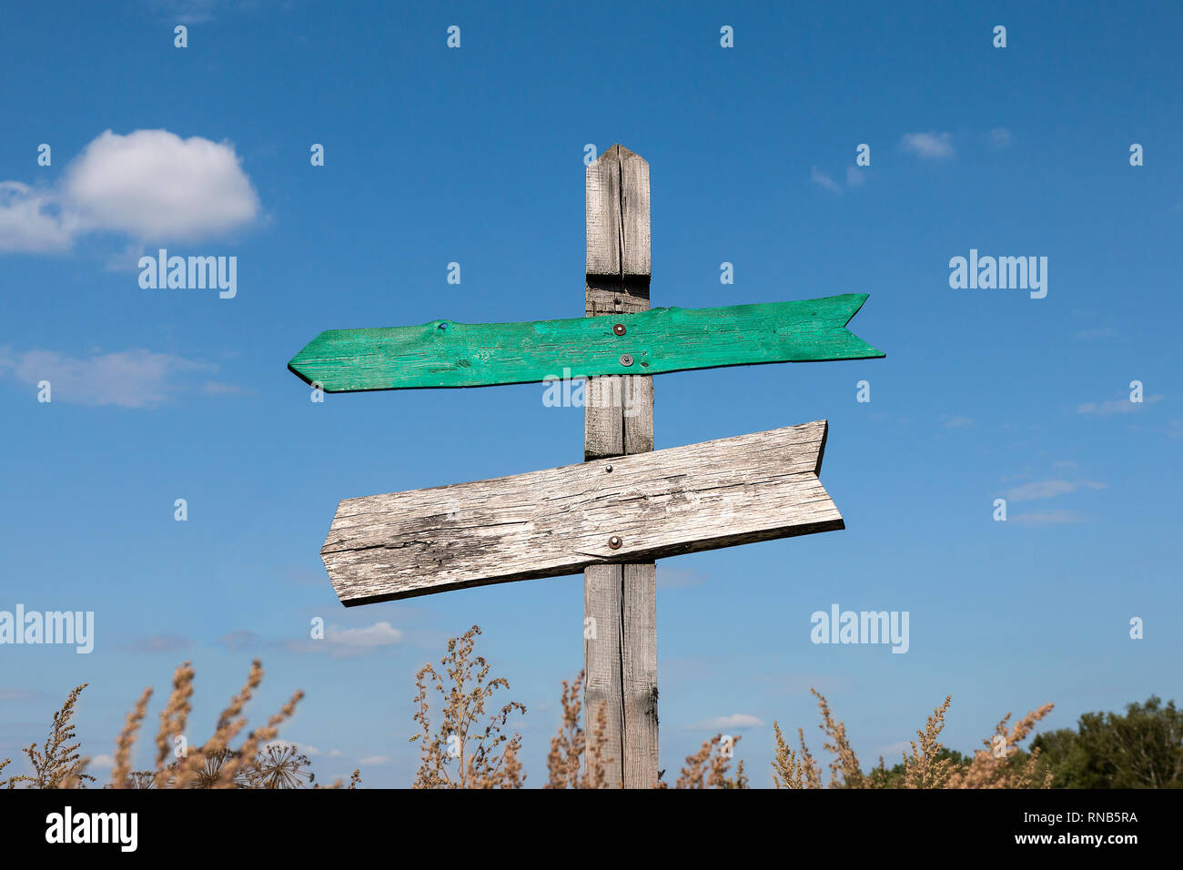 old wooden signpost with two arrows with copy space Stock Photo - Alamy