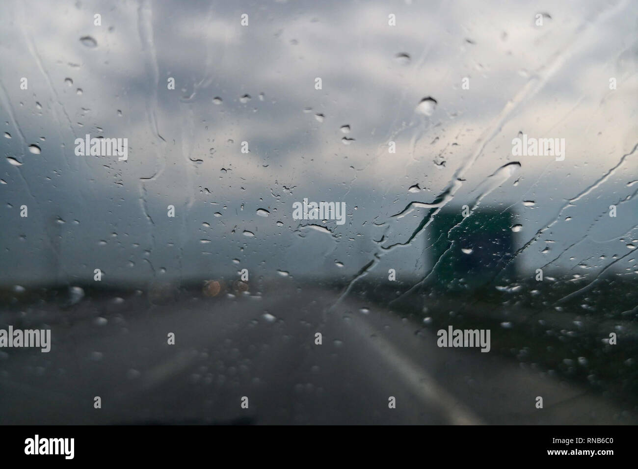 Image of a car's wind screen, driving through the rain Stock Photo - Alamy