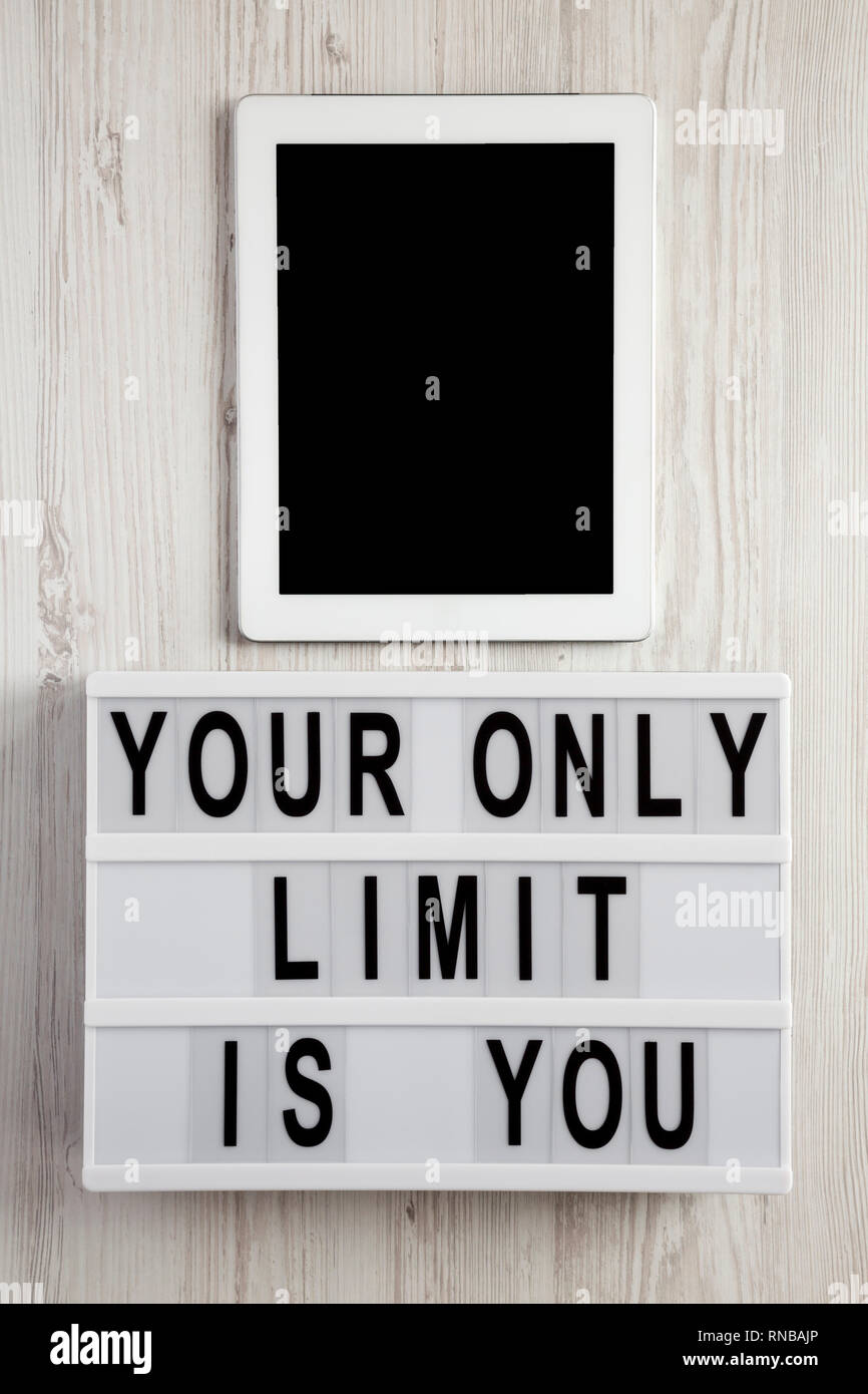'Your only limit is you' word on lightbox, tablet with blank screen on ...