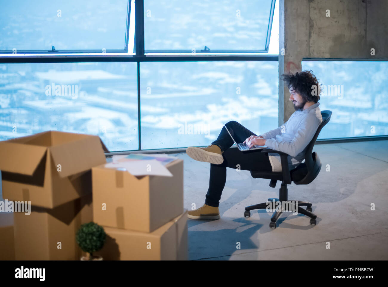 young male architect on construction site checking documents and ...