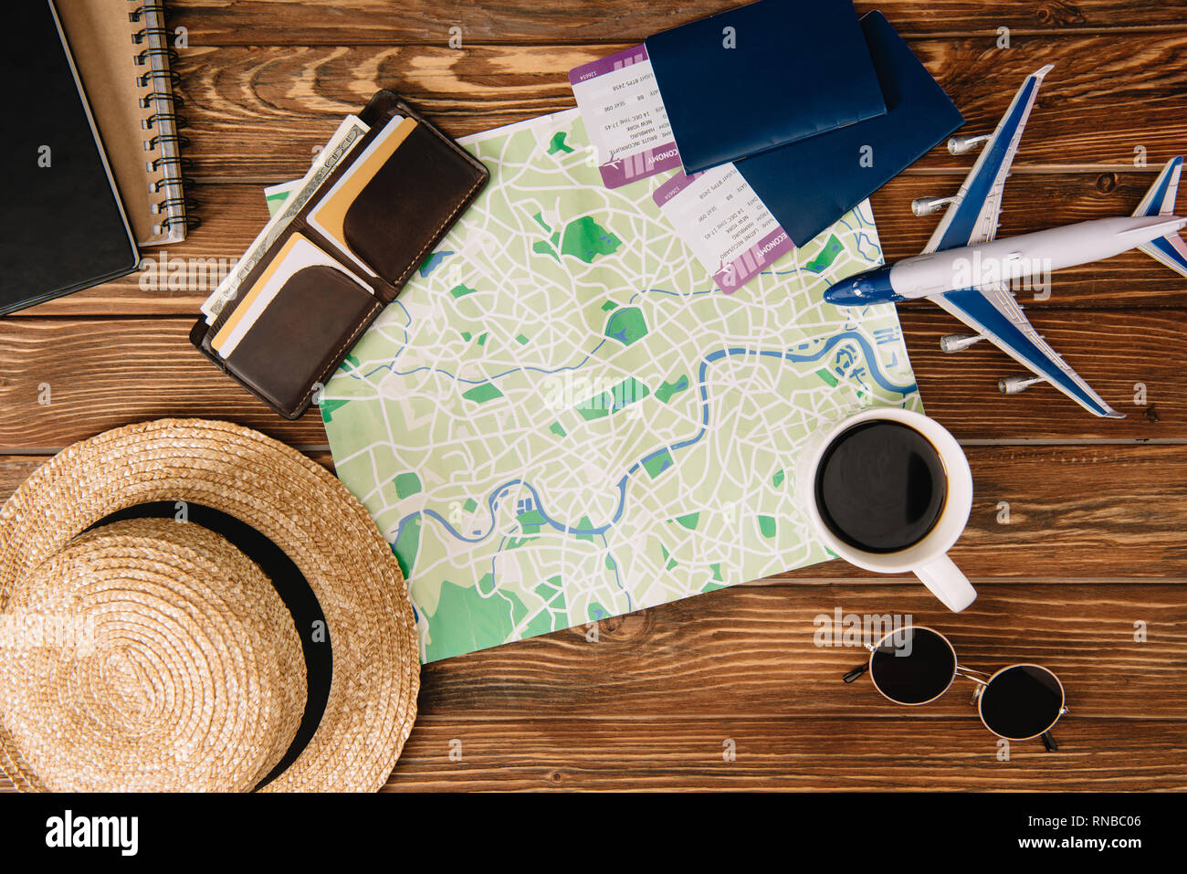 top view of accessories, map, passports with tickets and plane model on ...