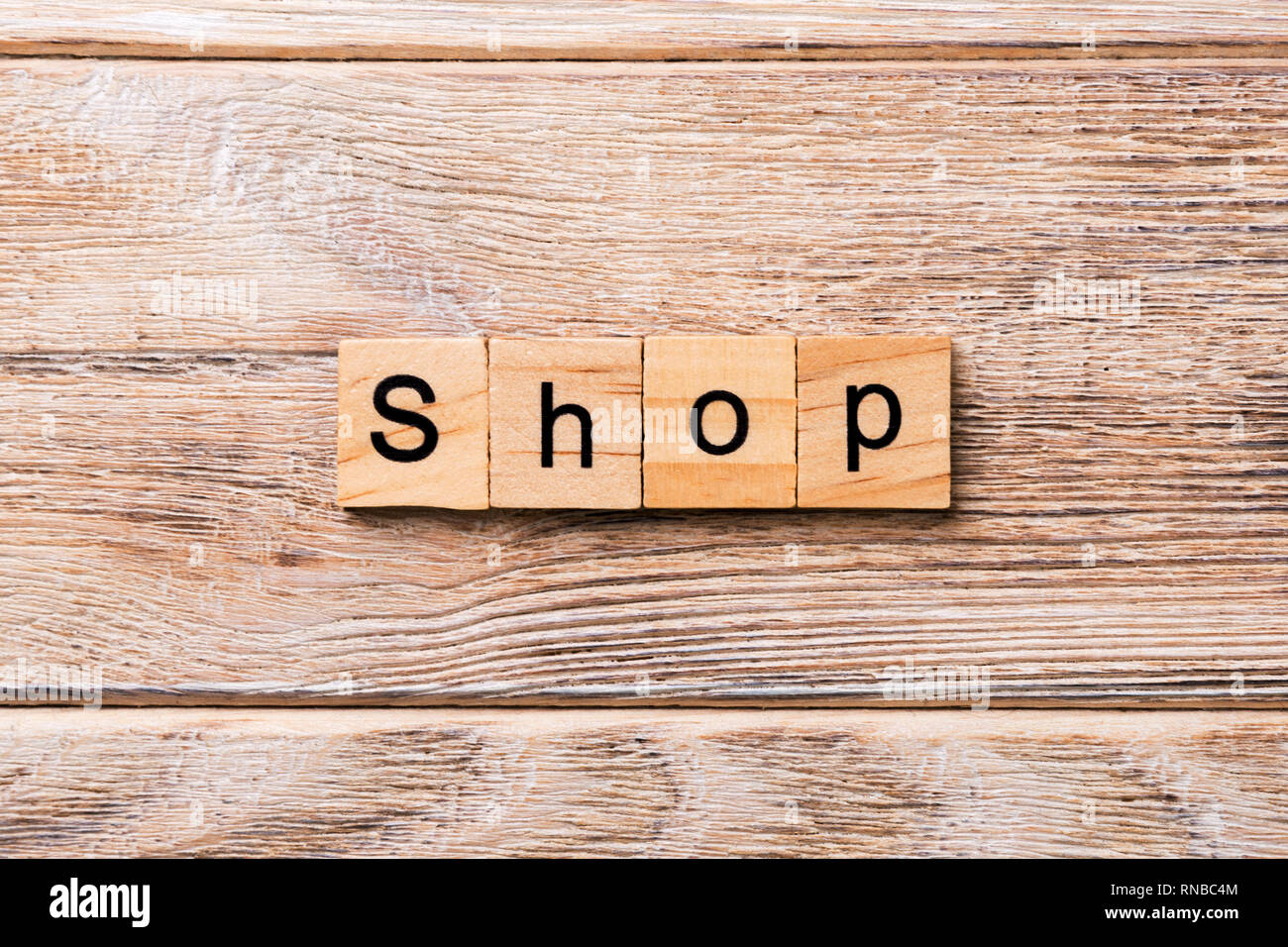 shop word written on wood block. shop text on wooden table for your ...