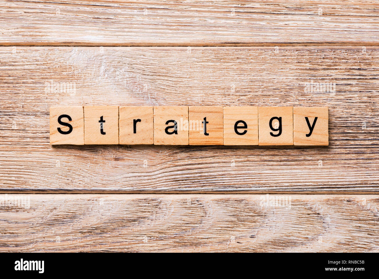 STRATEGY word written on wood block. STRATEGY text on wooden table for ...