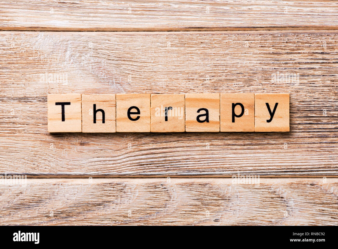therapy word written on wood block. therapy text on wooden table for ...