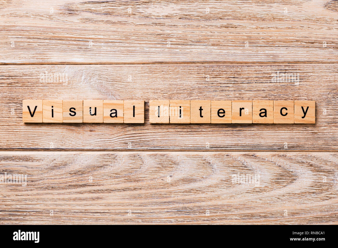 visual literacy word written on wood block. visual literacy text on ...