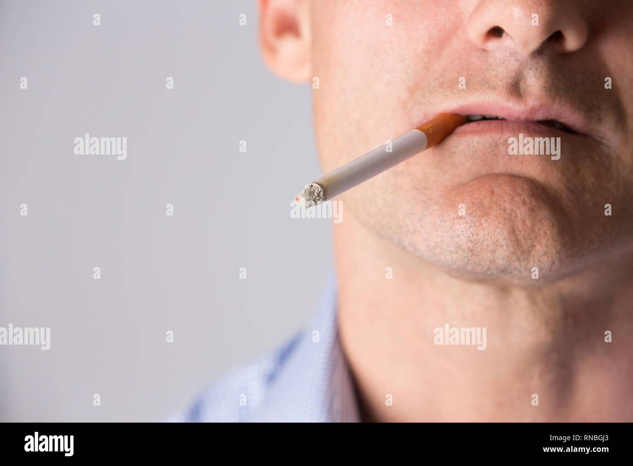 Studio Close Up Of Man Smoking Cigarette Stock Photo - Alamy