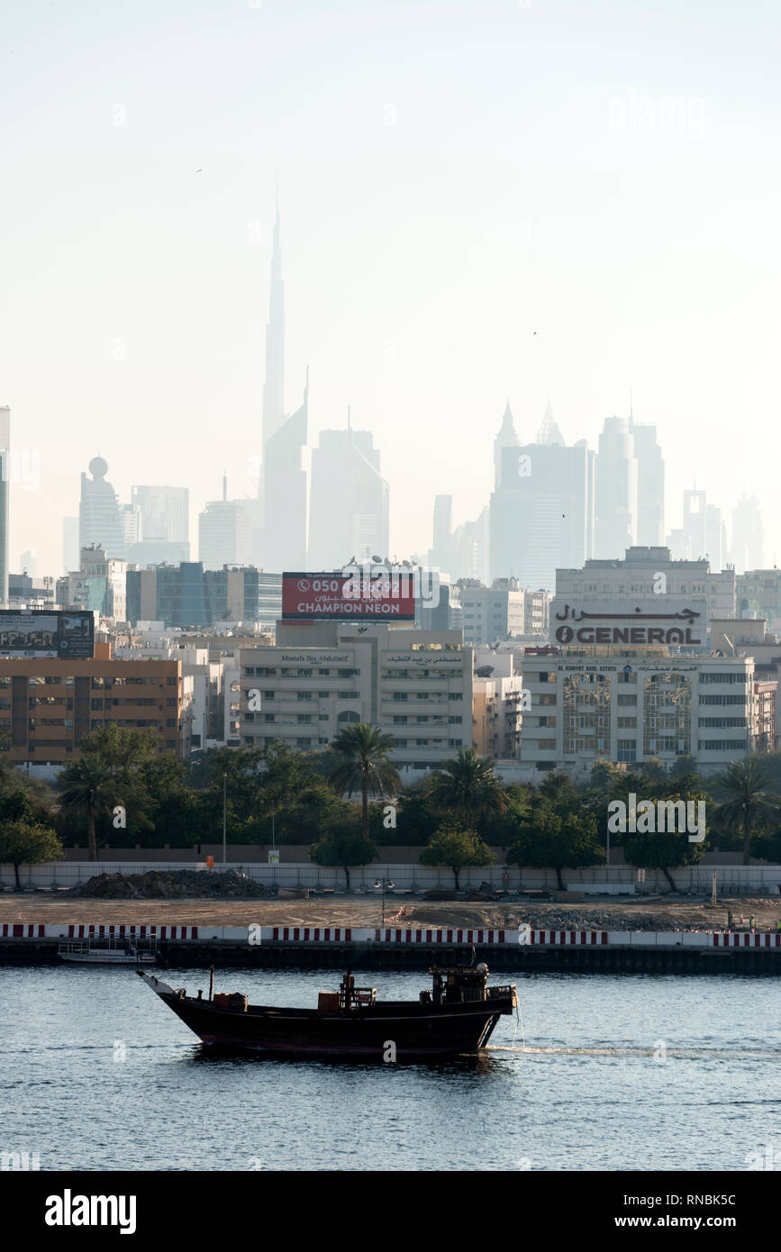 A Dhow ( Arabic boat) cruises along on the Dubai Creek in Dubai in the ...