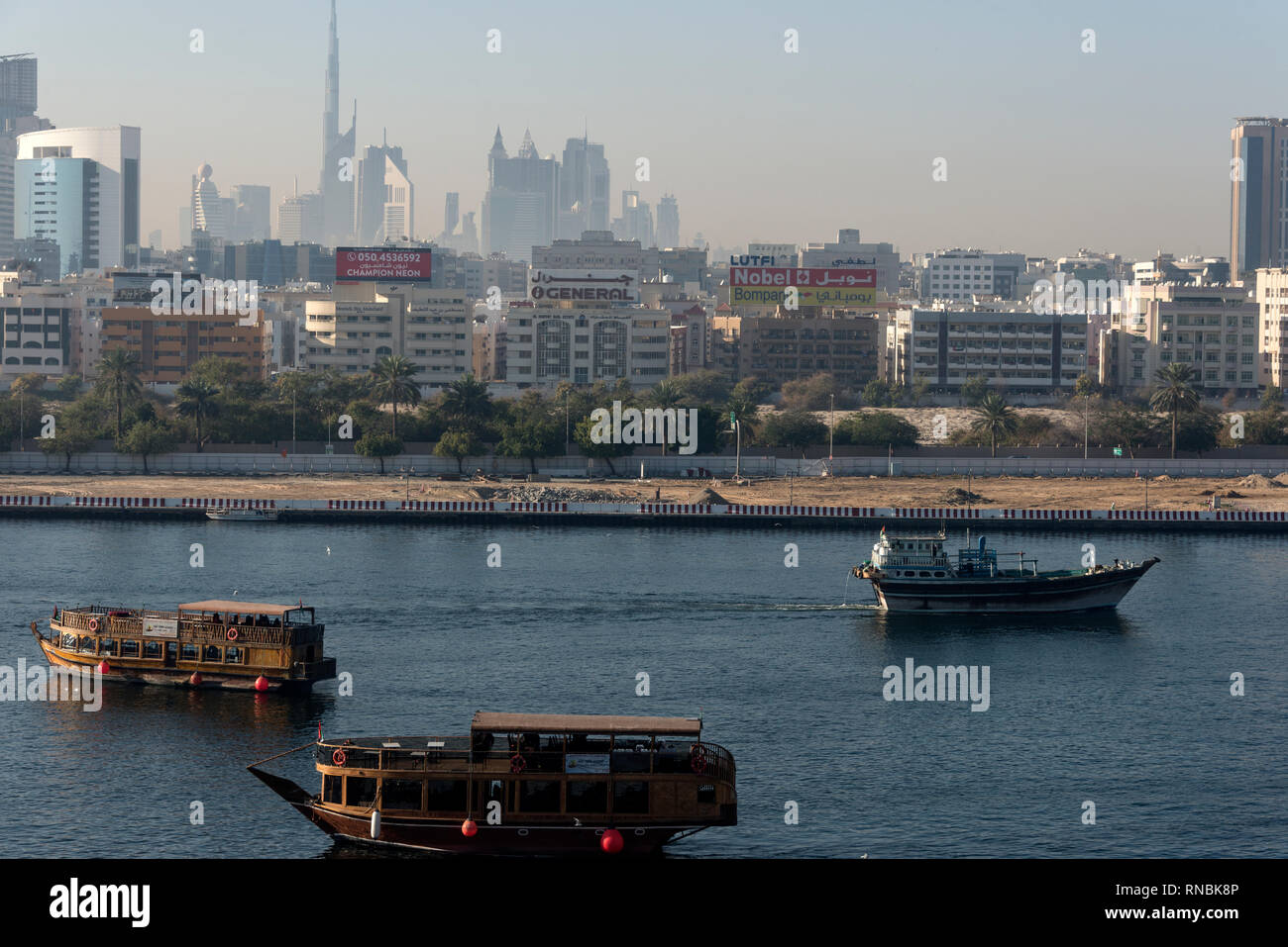 Tourist carrying Dhows ( Arabic boat) cruising down the Dubai Creek in ...