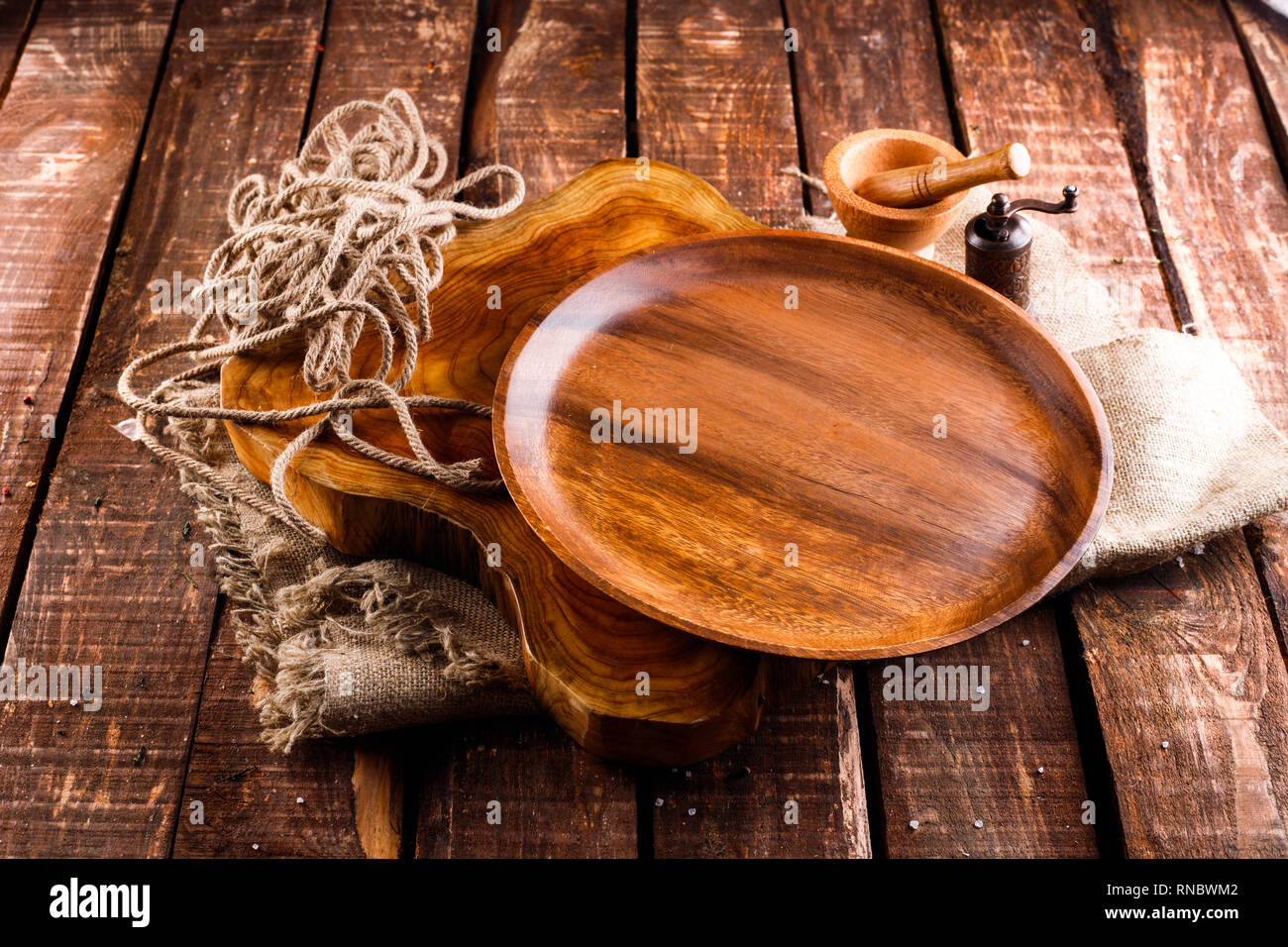 The brown wooden plate on a rustic table closeup. horizontal top view ...