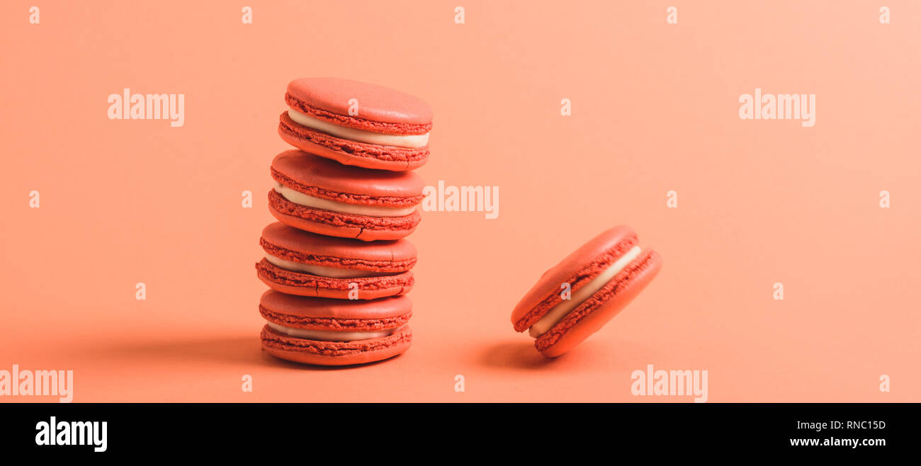 delicious macarons on coral background, color of 2019 concept Stock ...