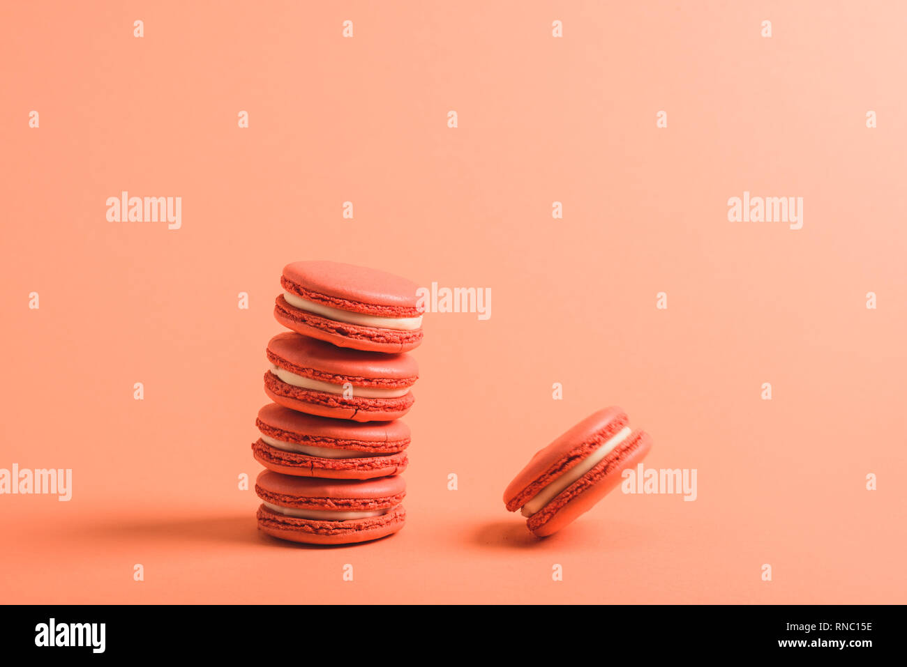 tasty coral macarons on coral background, color of 2019 concept Stock ...