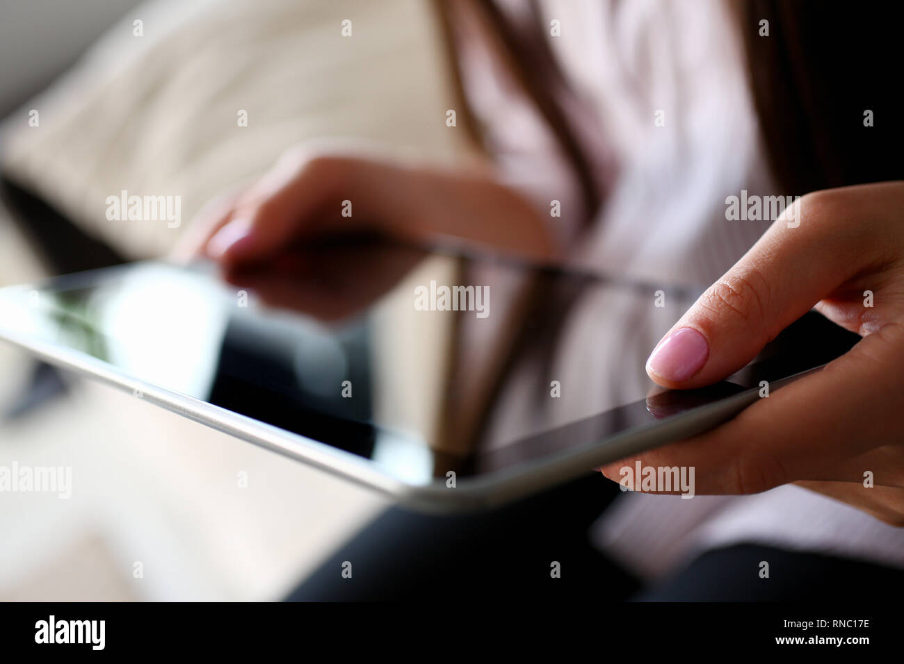 female hand holds tablet in home setting while Stock Photo - Alamy