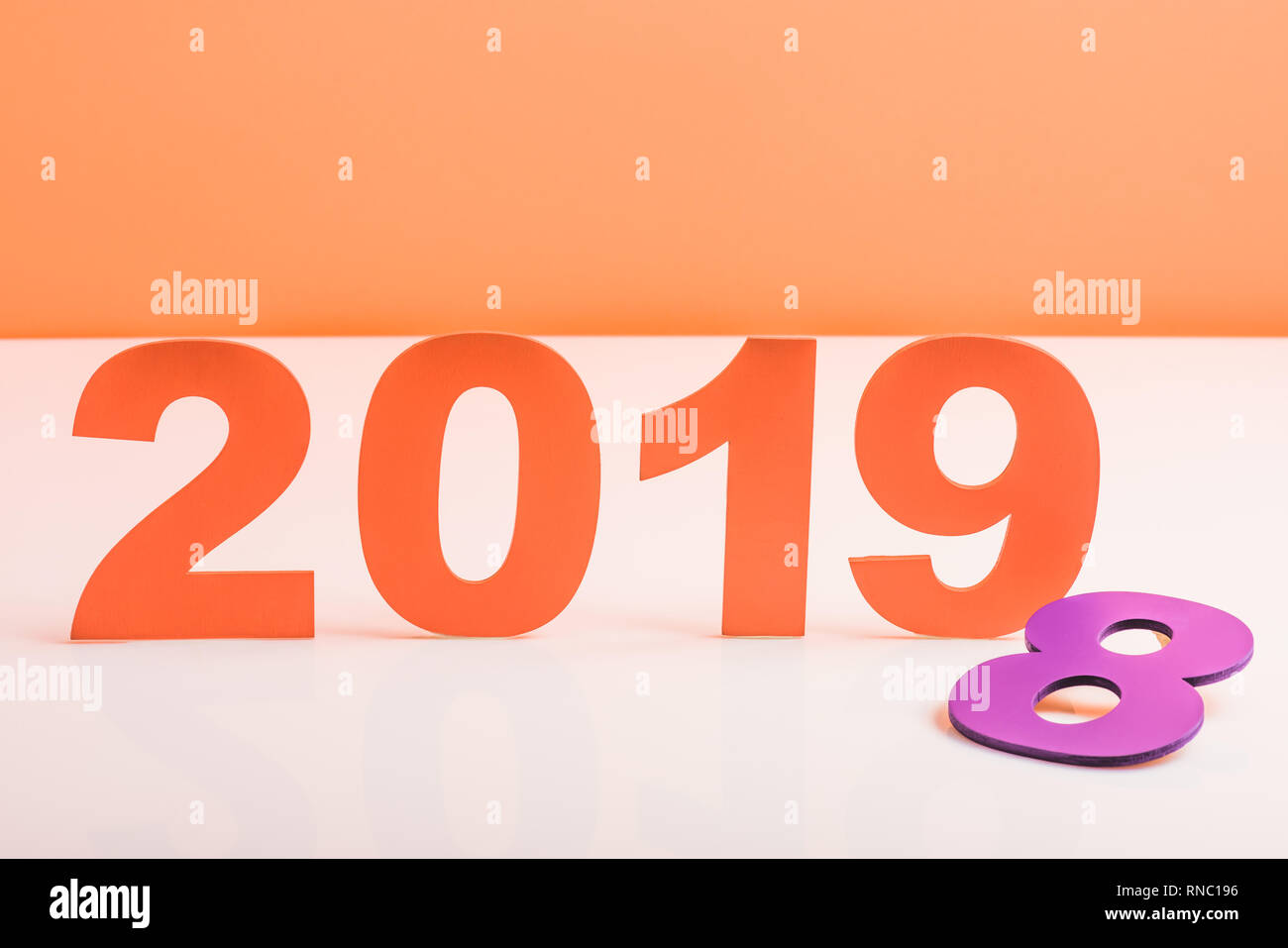 coral paper cut 2019 numbers and violet number 8 on white surface ...