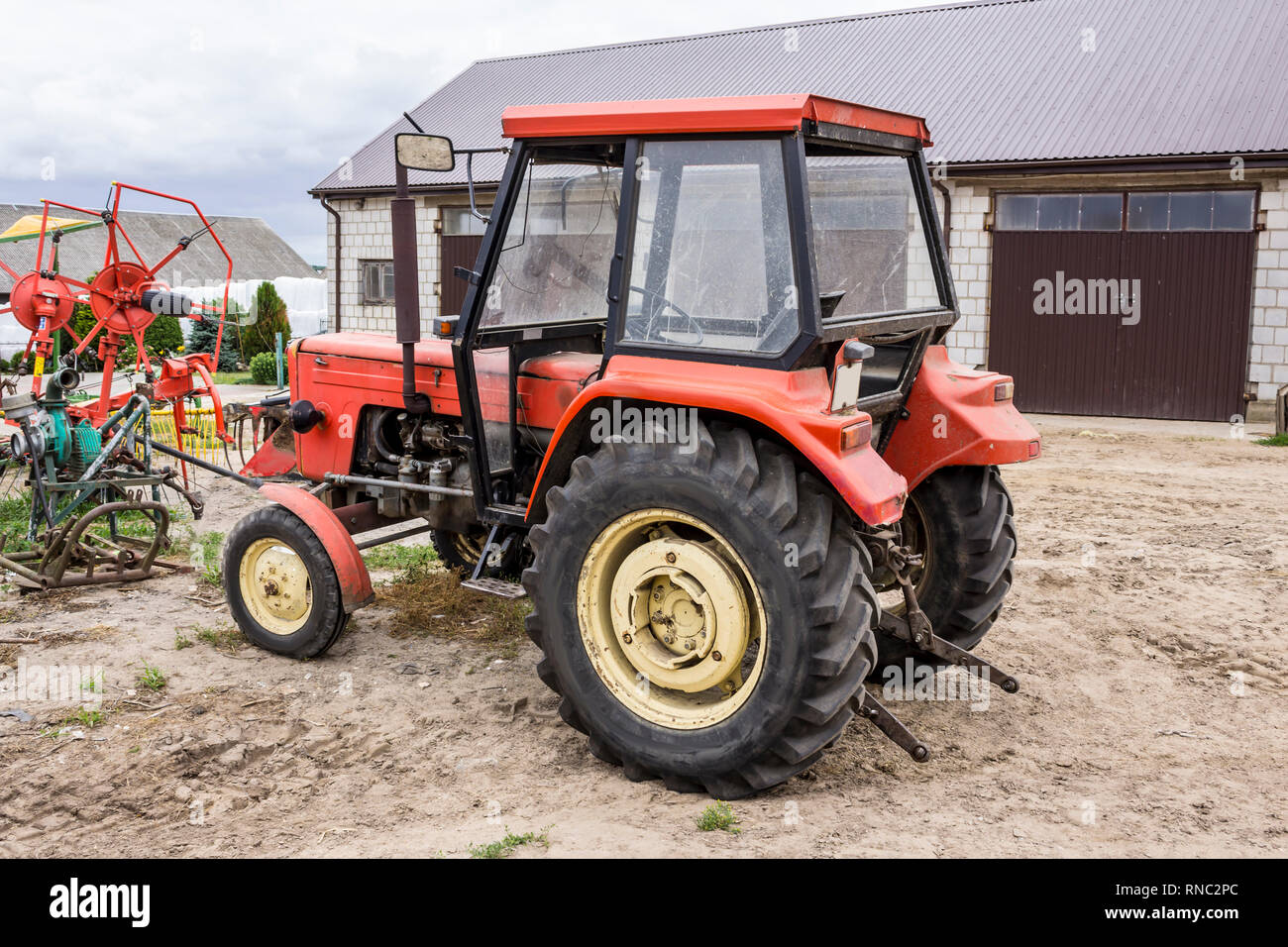 Old tractor for works in a fields ,where cultivated corn and grass for ...