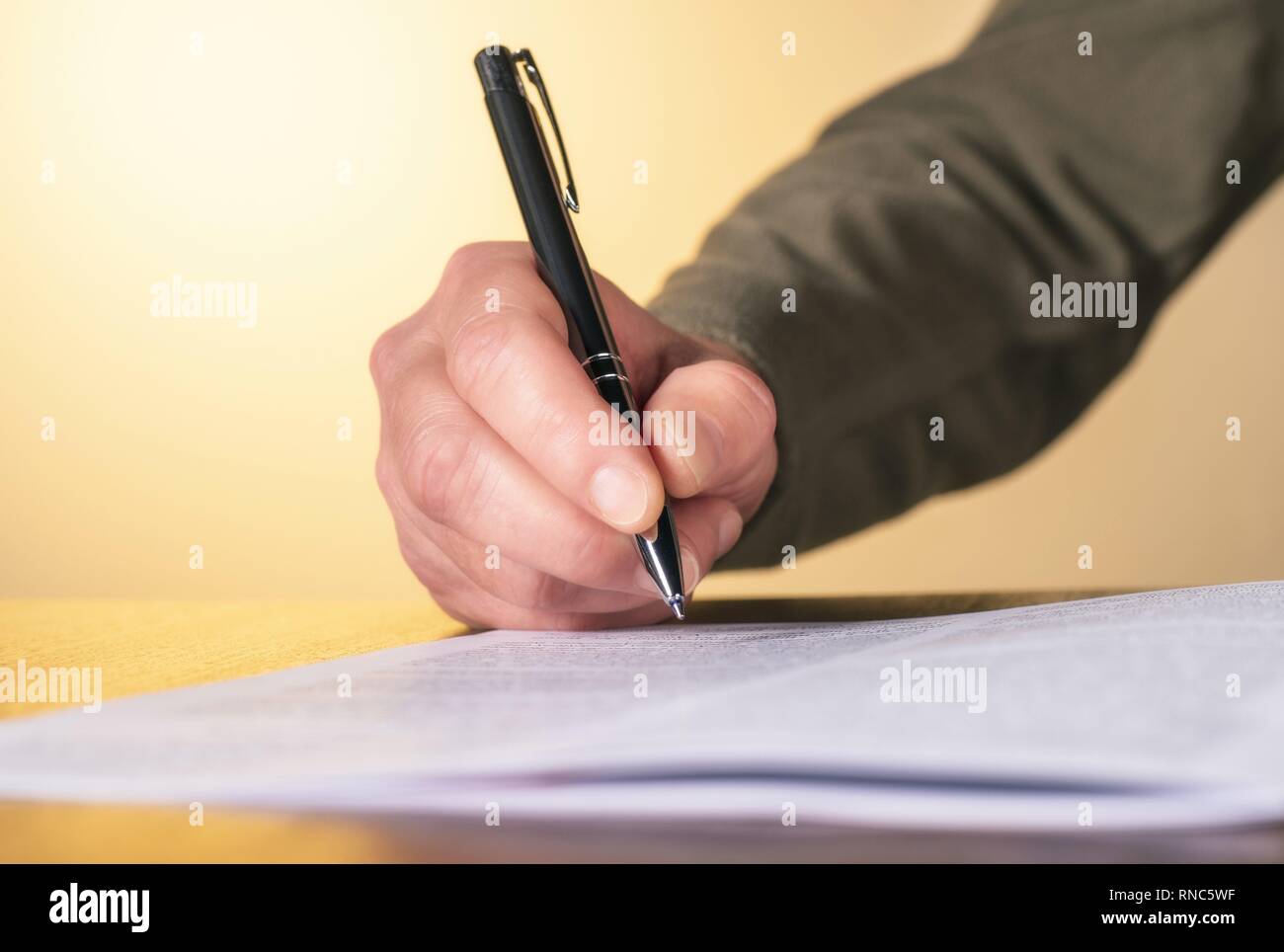 Hand of a man with pen while inspecting a document | usage worldwide ...