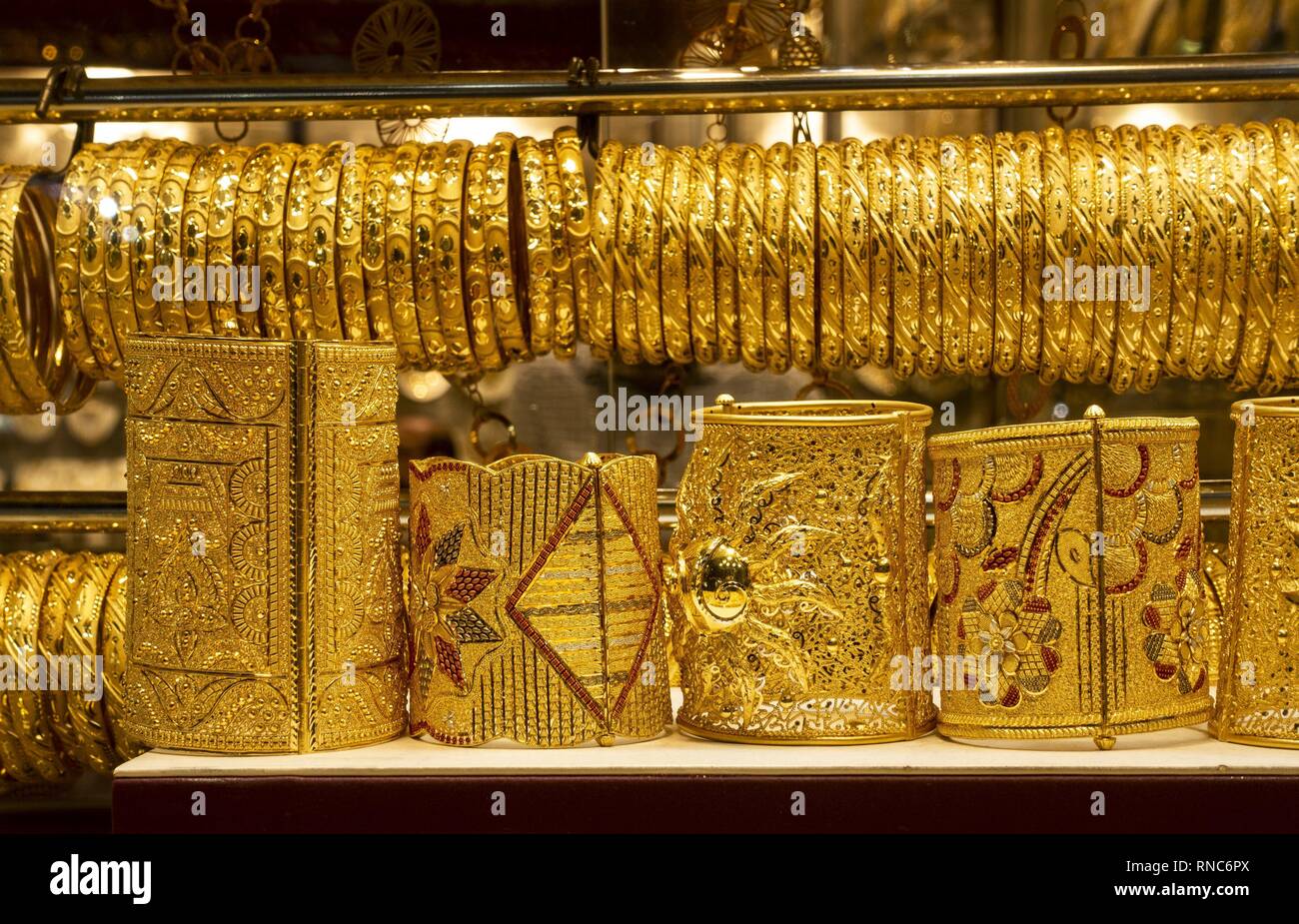 Gold bracelets fill the display of a shop in the Goldsuq of Dubai ...