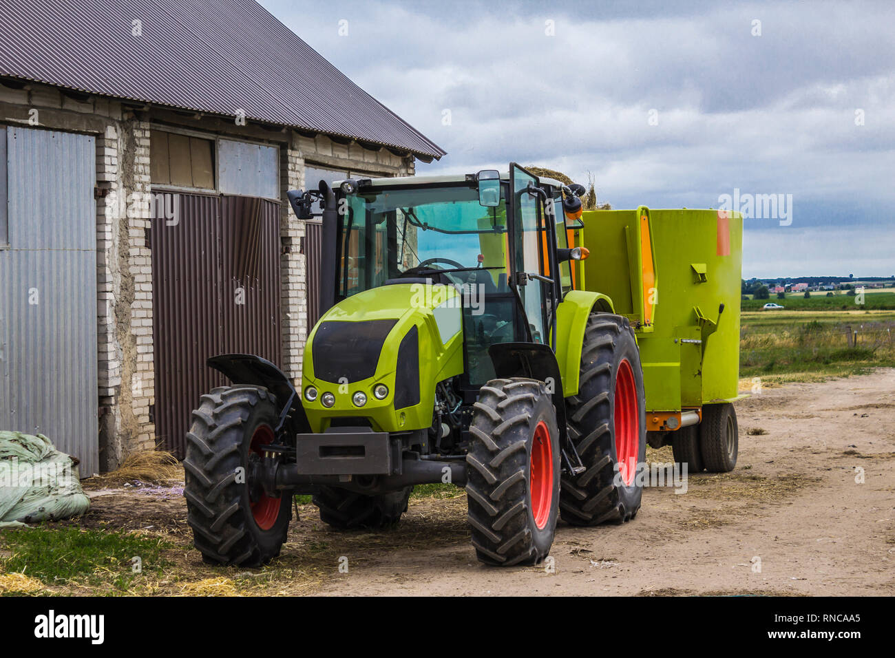 Tractor with a trailer for mixing and distribution of feed for cows ...