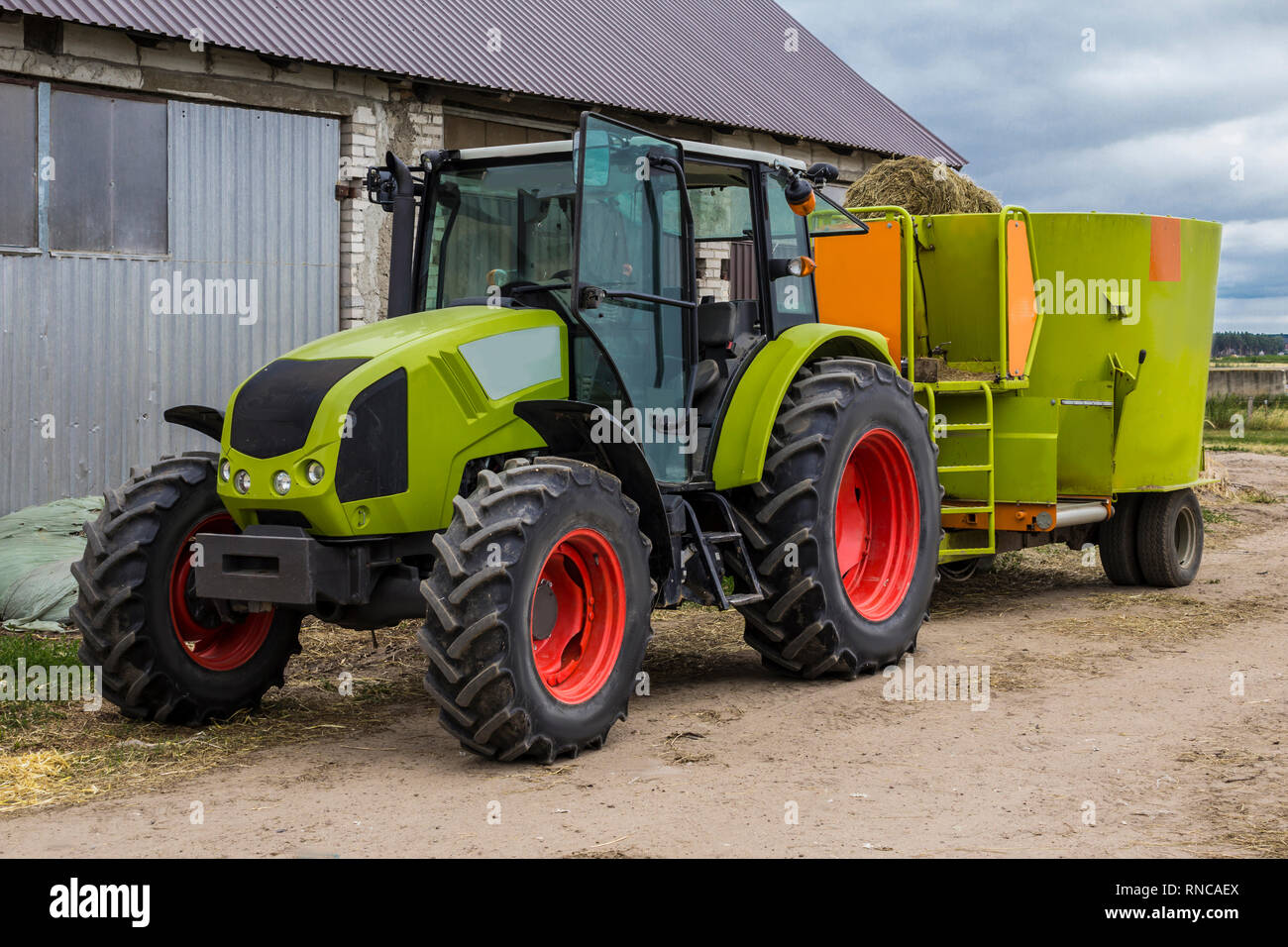 Tractor with a trailer for mixing and distribution of feed for cows ...