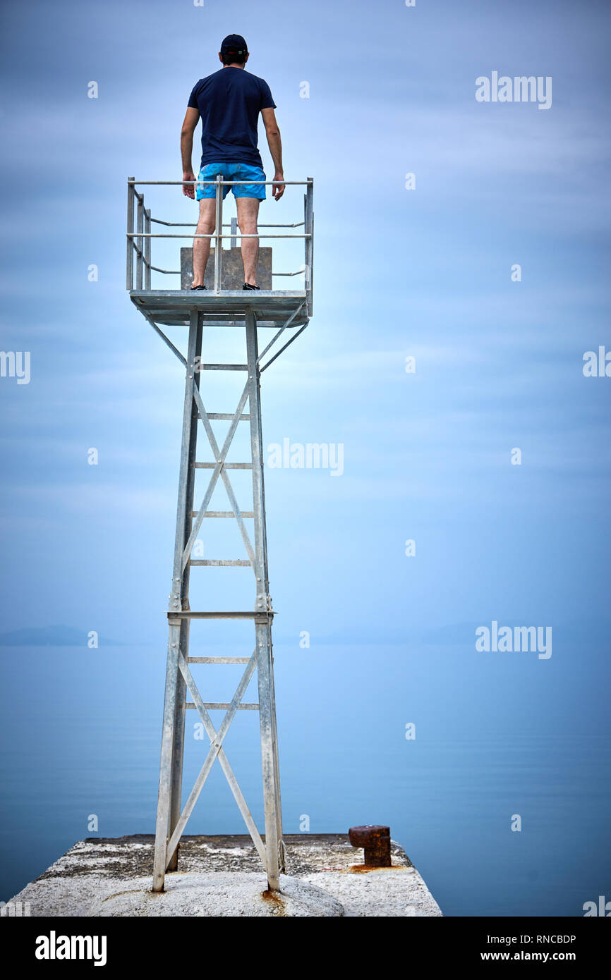 Lifeguard sitting in his chair watching the sea Stock Photo - Alamy
