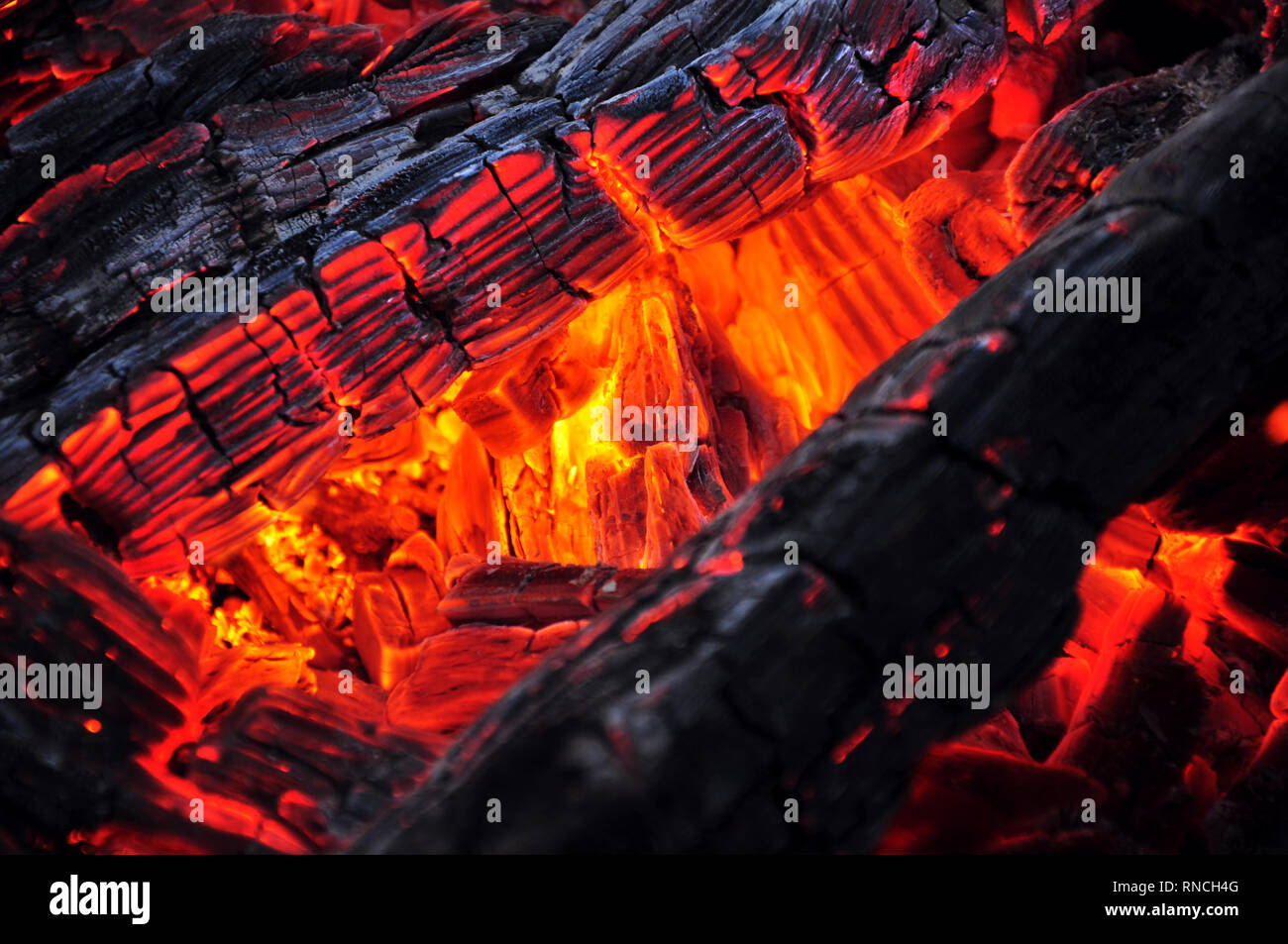 Beautiful color of burning red coals and black charred wood. Orange hot ...