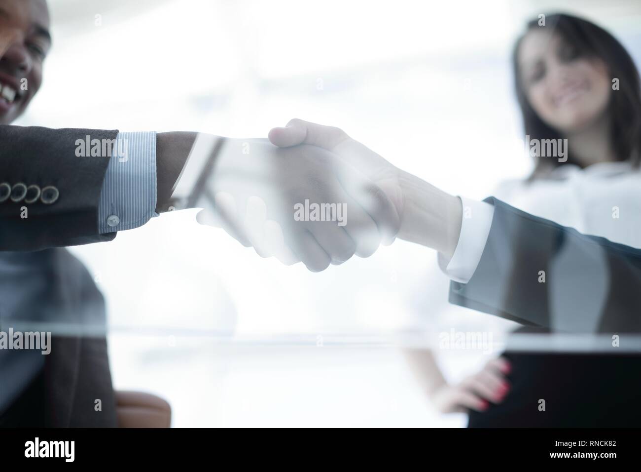 business background. handshake of business partners above the Desk ...