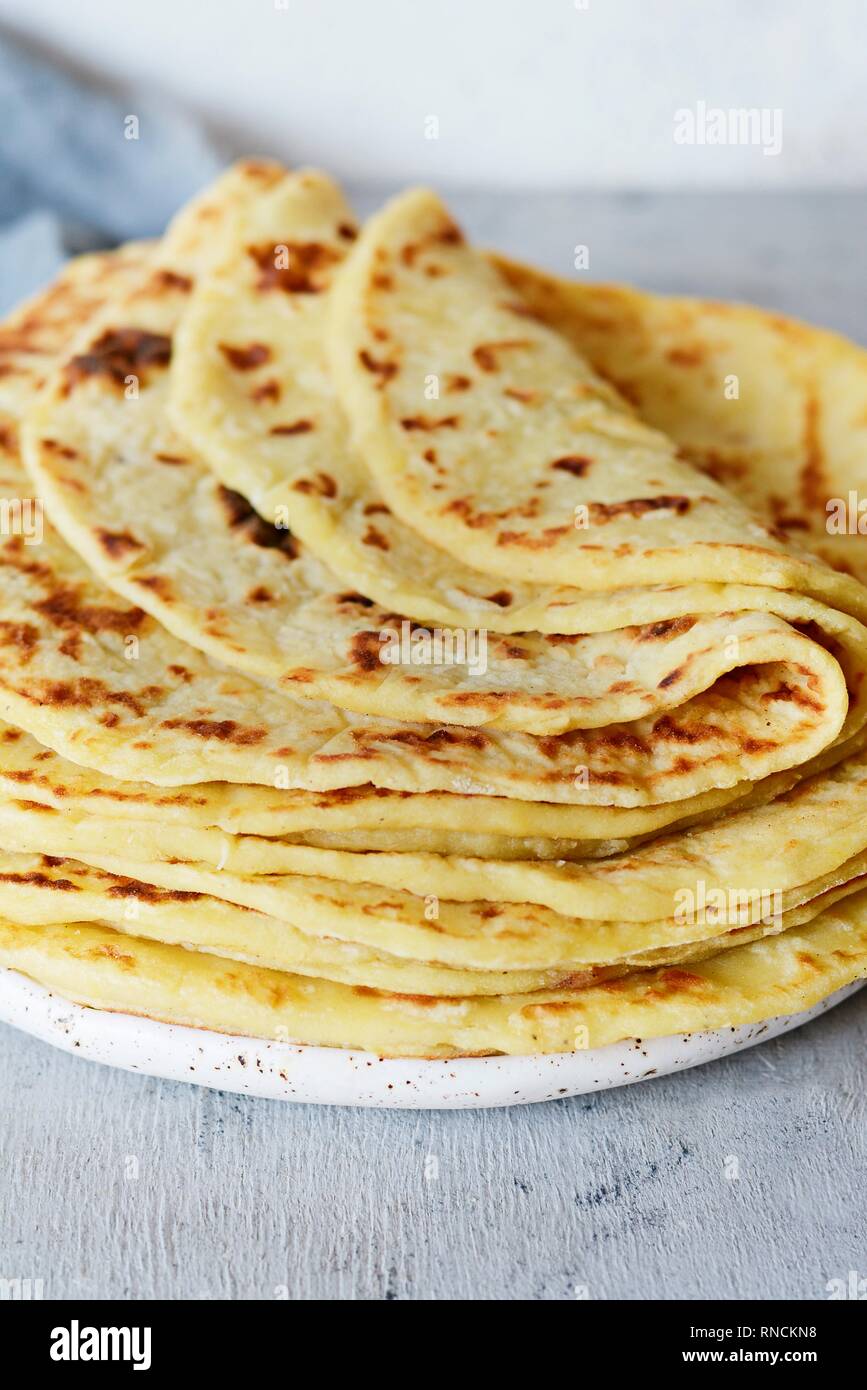 Norwegian potato pancakes Lefse on a light background with cheese and ...