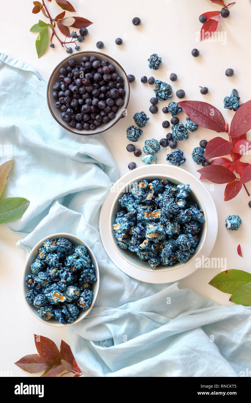 Blueberry popcorn and blueberries in bowls on a white background Stock ...