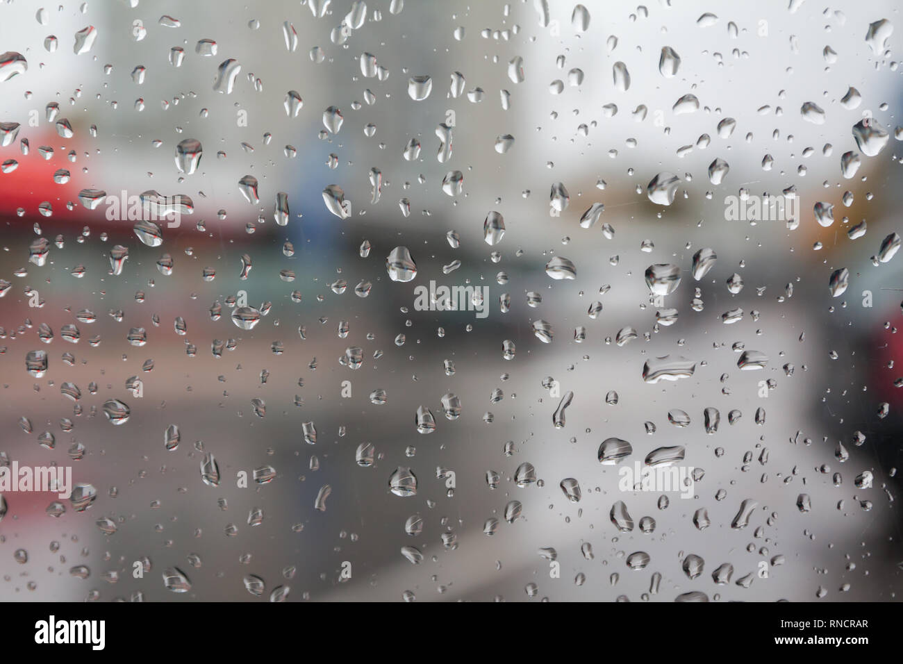 Rain drops on car glass, focus on raindrops. View to the street Stock ...