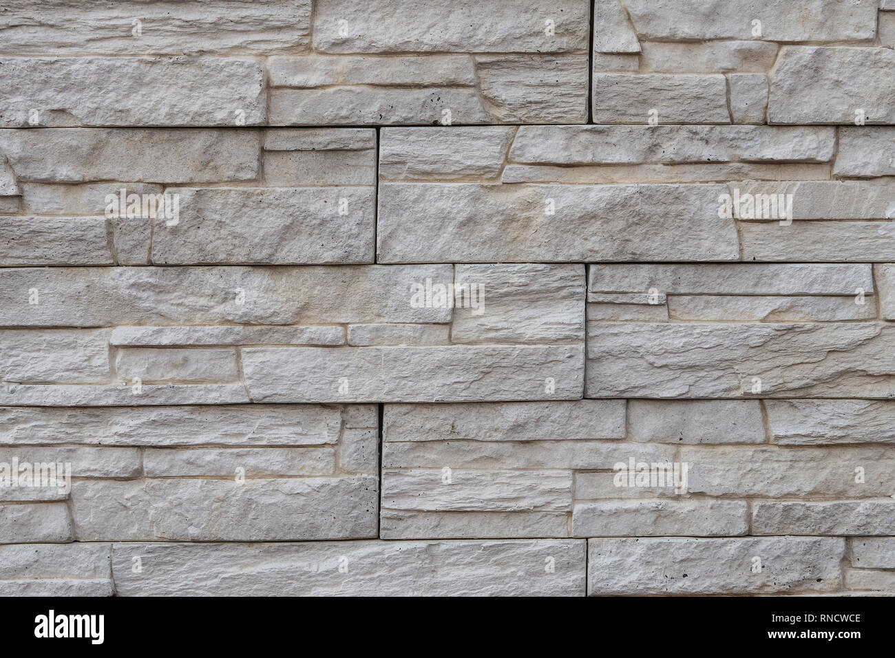 White stone bricks texture, rocky wall surface closeup. Grunge rock ...