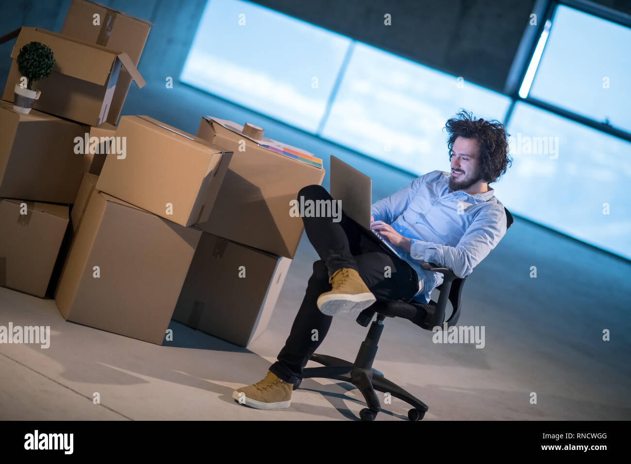 young male architect on construction site checking documents and ...