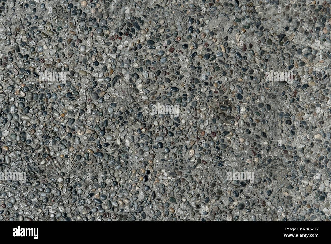Little smooth cobblestones filled with cement, wall decoration texture ...